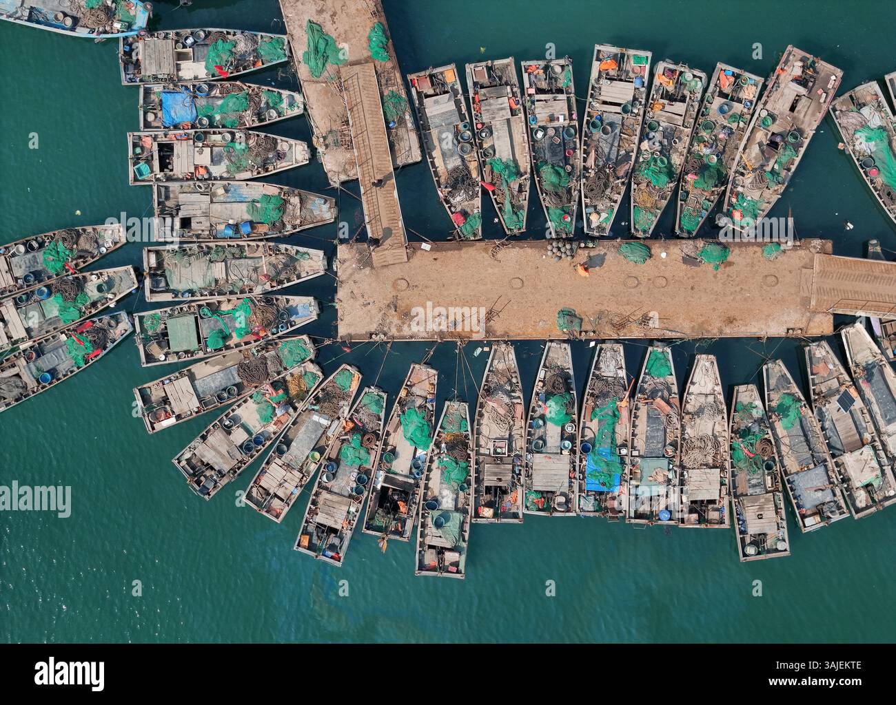 YANTAI, CHINA - APRIL 11, 2025 - Fishing boats take shelter from ...