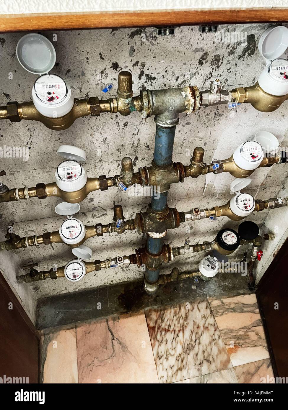 A close-up of water meters and plumbing system in a building in Lisbon ...