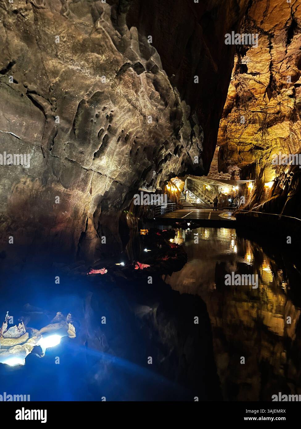 Spectacular underground cave with reflective waters and illuminated ...