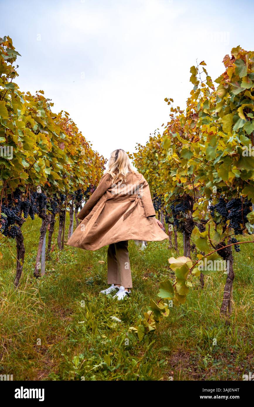 Happy woman well-dressed enjoys a beautiful day of September in an ...