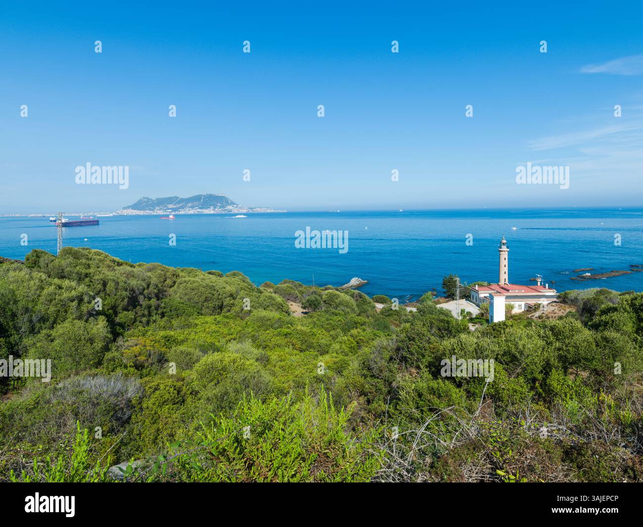Faro de Punta Carnero and Gibraltar Rock, Parque Natural del Est Stock ...