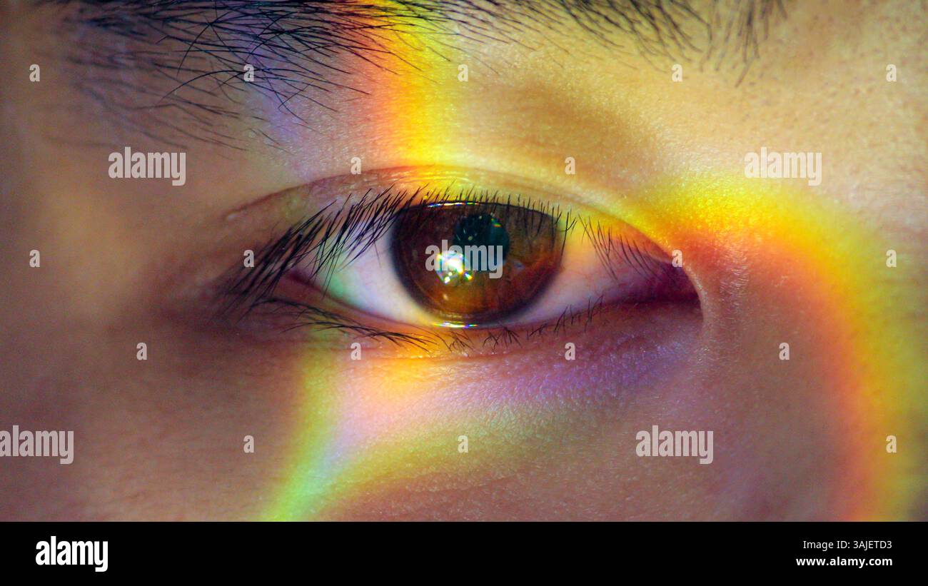 Eye with vibrant rainbow light streaks and deep reflection Stock Photo ...