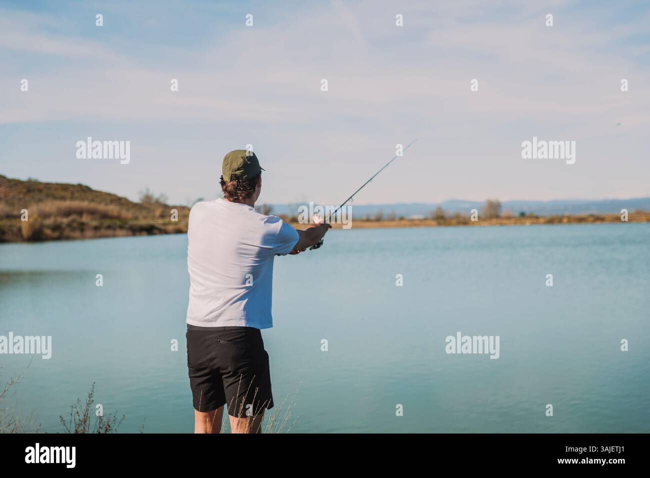 Person fishing alone calm lake hi-res stock photography and images - Alamy
