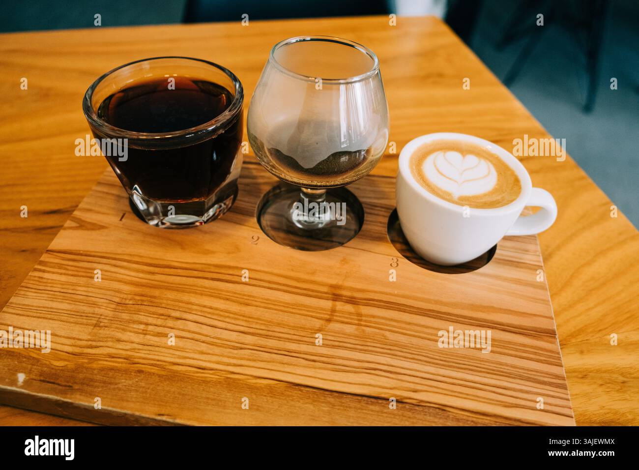 Exploring different coffee varieties at a cozy cafe Stock Photo - Alamy
