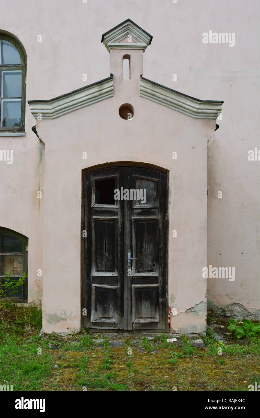 Entrance to the old building. Old building facade fragment with cracked ...