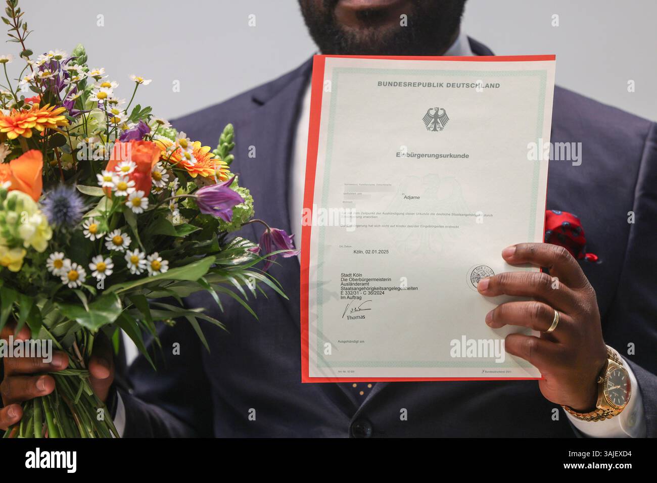 Cologne, Germany. 11th Apr, 2025. A participant in the naturalization ...