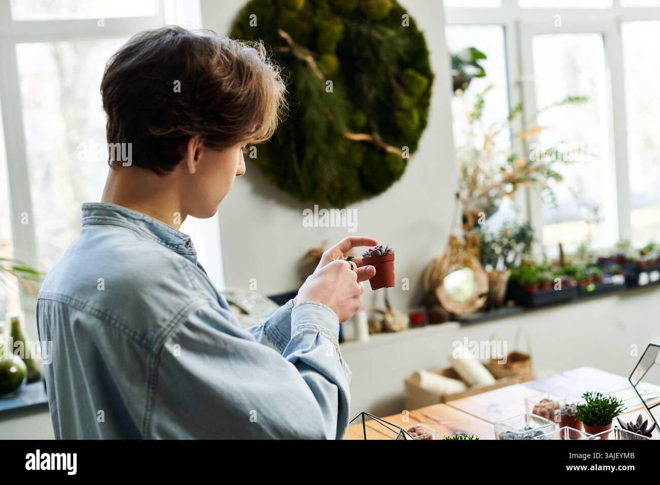 Young artist engages with creativity while examining a small plant in ...