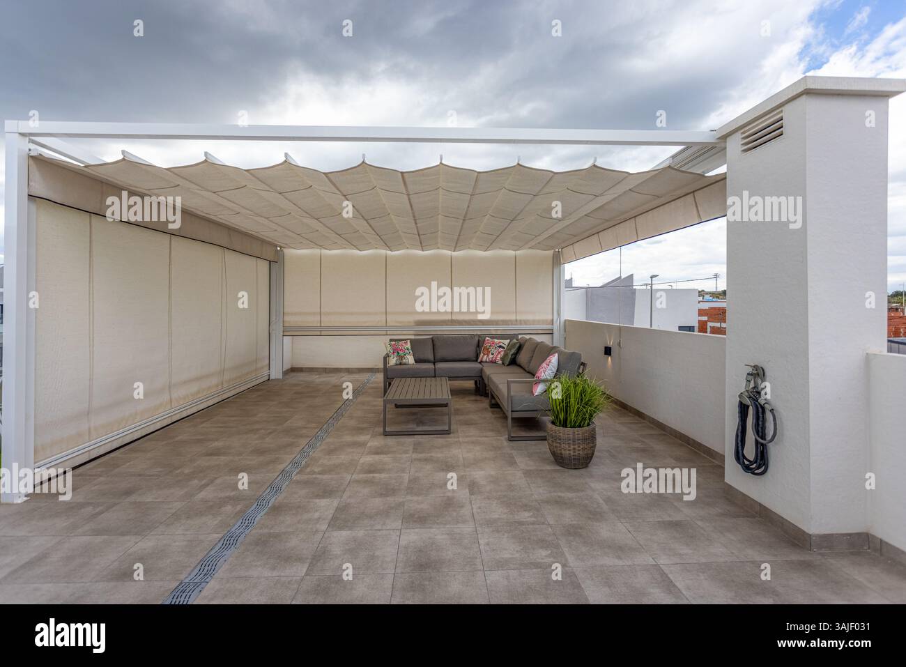 Covered rooftop space with lounge furniture, ideal for relaxing ...