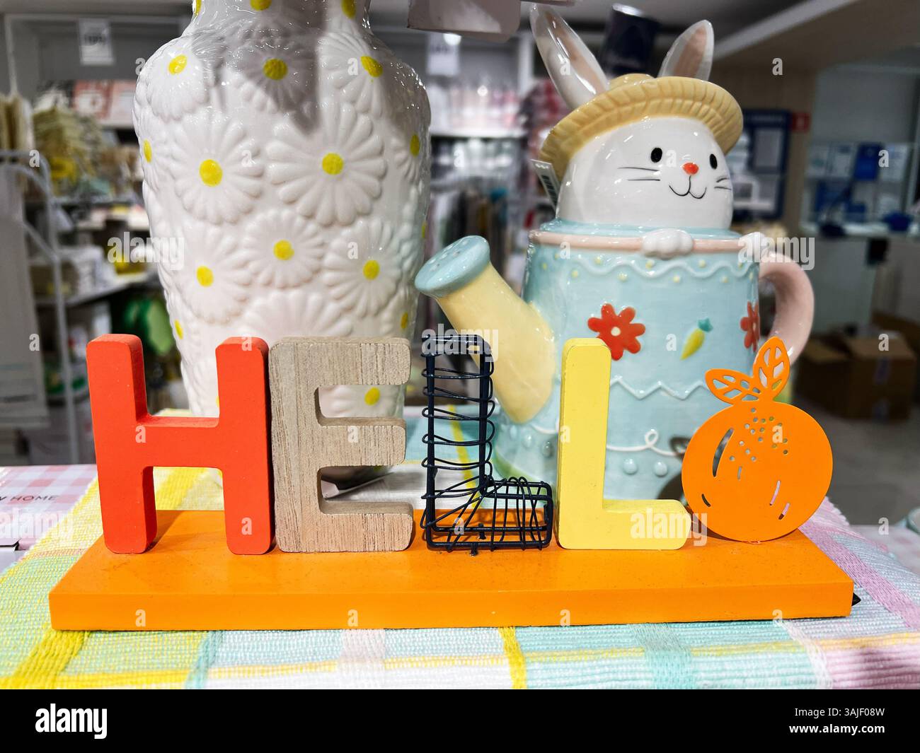 Vibrant decorative setup with Hello text sign, rabbit teapot, and ...