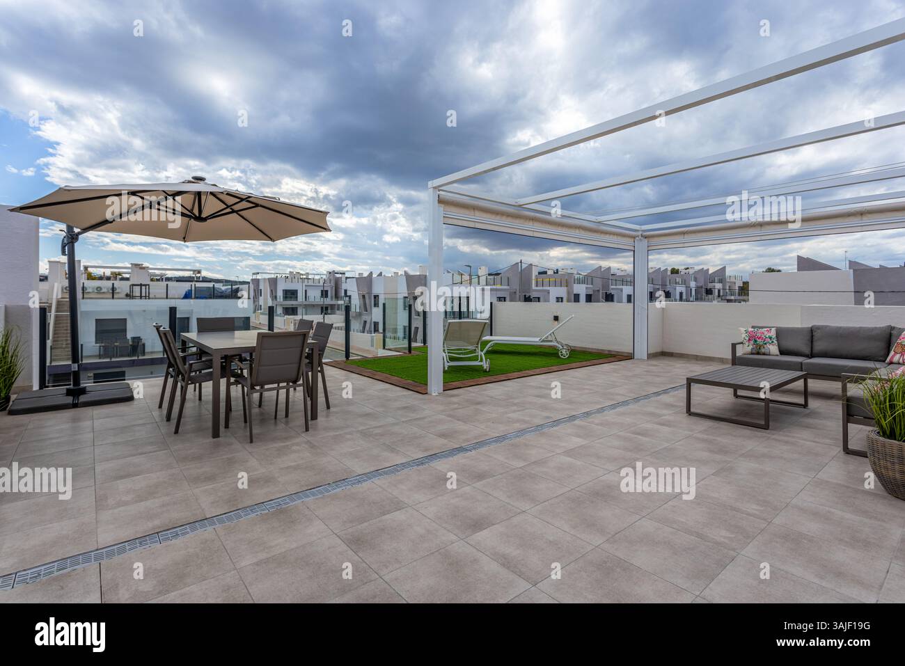 Sleek rooftop setup with dining and sunbathing zones, ideal for ...