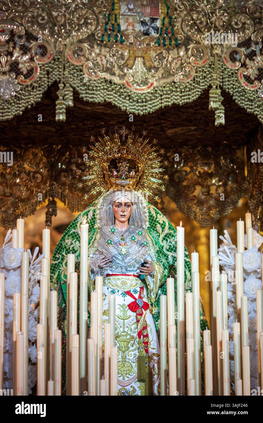 The Virgin of Esperanza Macarena stands adorned on her paso de palio ...