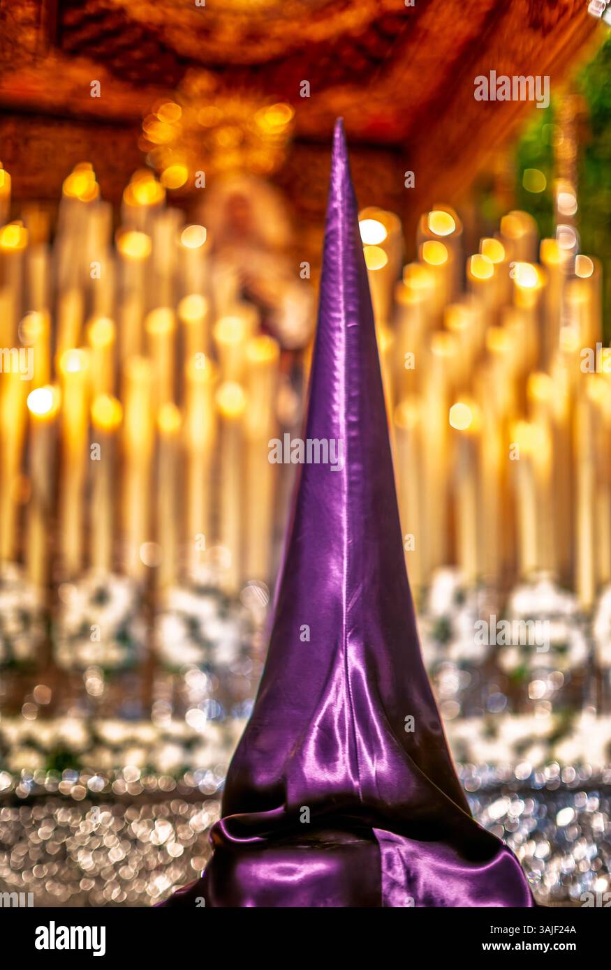 A penitent stands in reverence in front of the Virgin of Victory’s ...