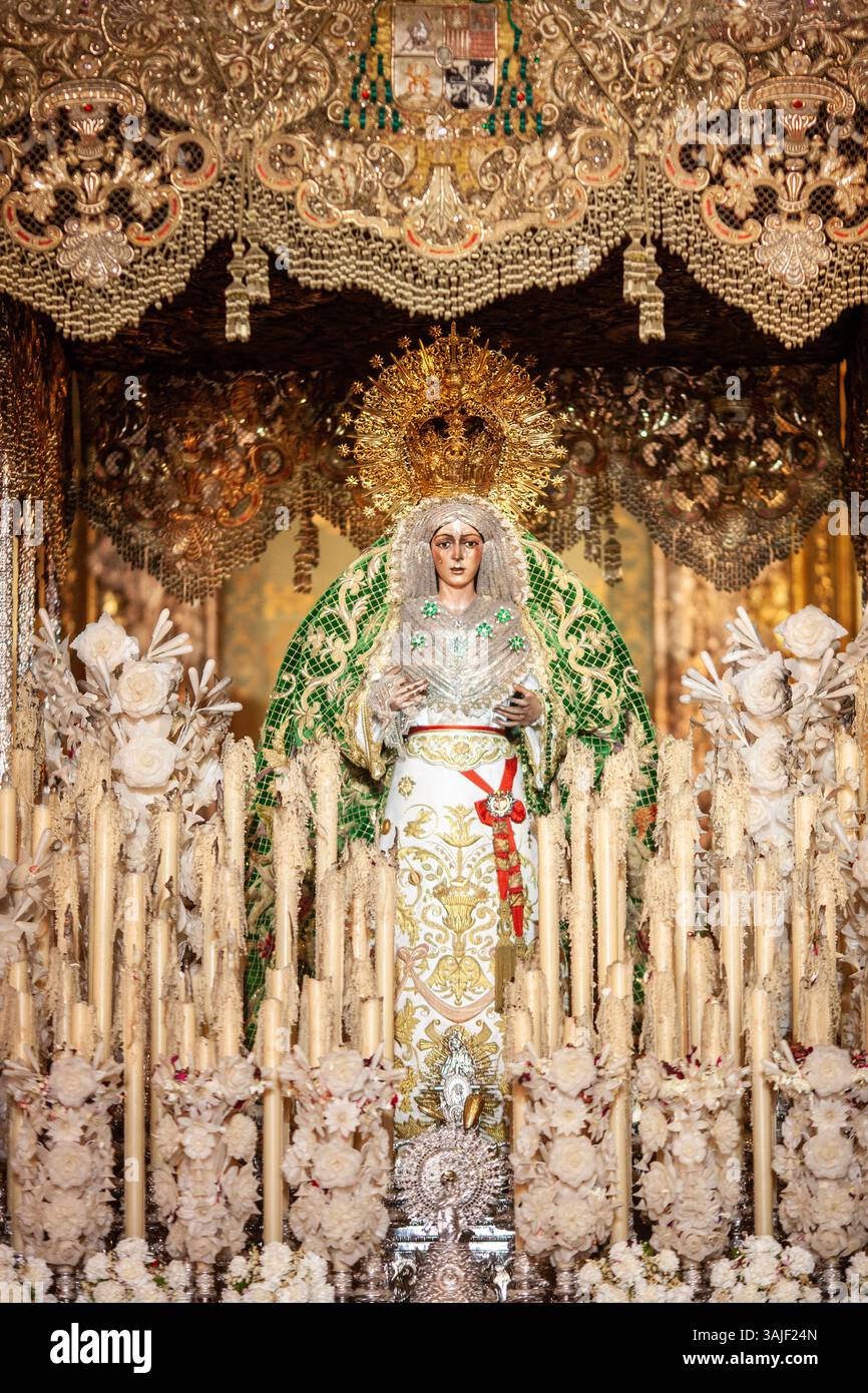 Virgin of Esperanza Macarena on her float surrounded by candles during ...