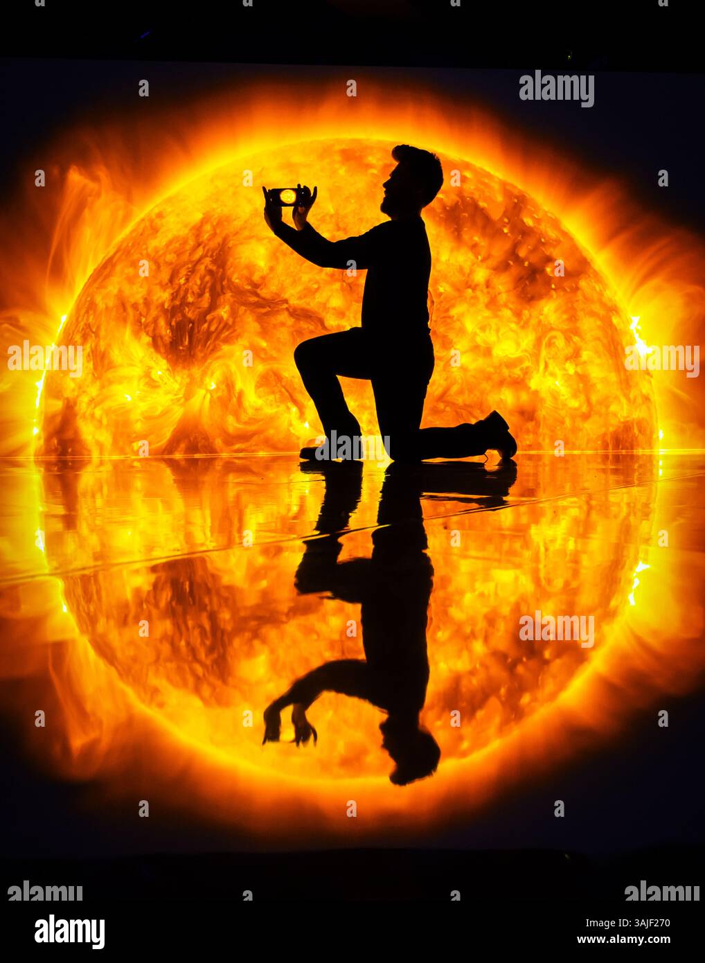 Tyler Robson takes a photograph the ancestry in the stars exhibit that ...