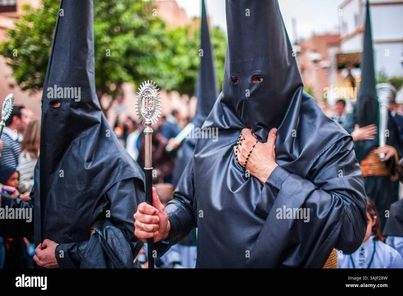 Hooded Nazareno participates in a solemn Holy Week procession in ...