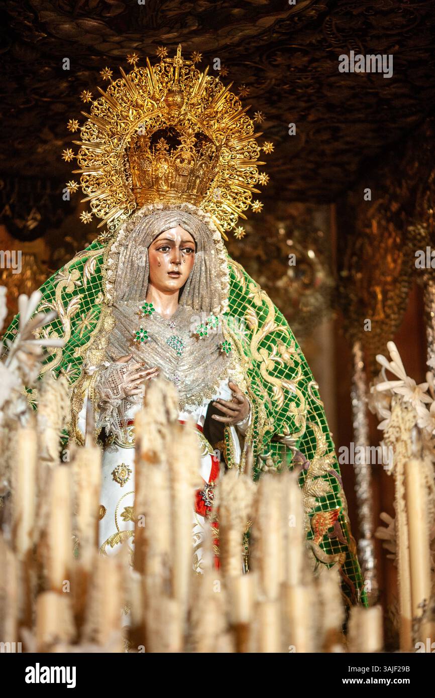 Virgin of Esperanza Macarena on her float surrounded by candles during ...