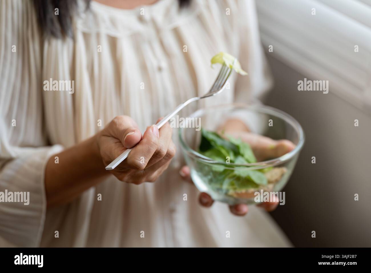 Healthy Eating and Wellness. An elderly individual enjoying a bowl of ...