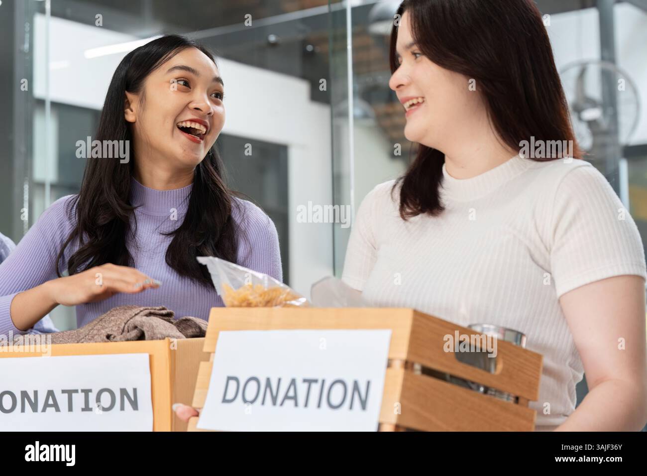 Collaboration and Positive Impact. Two friends joyfully sorting ...