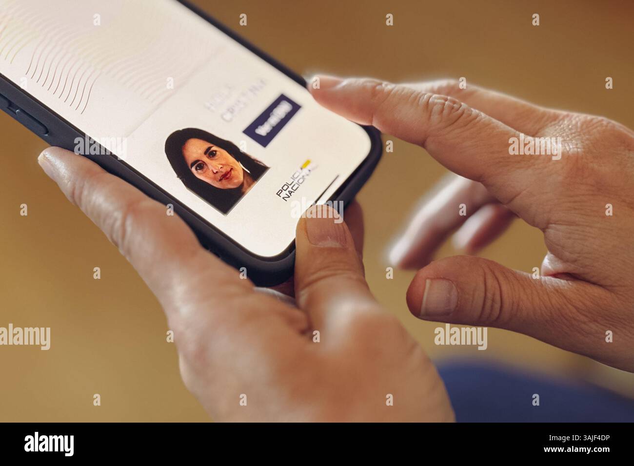 Hands of woman using the app for the new Spanish digital ID card that ...