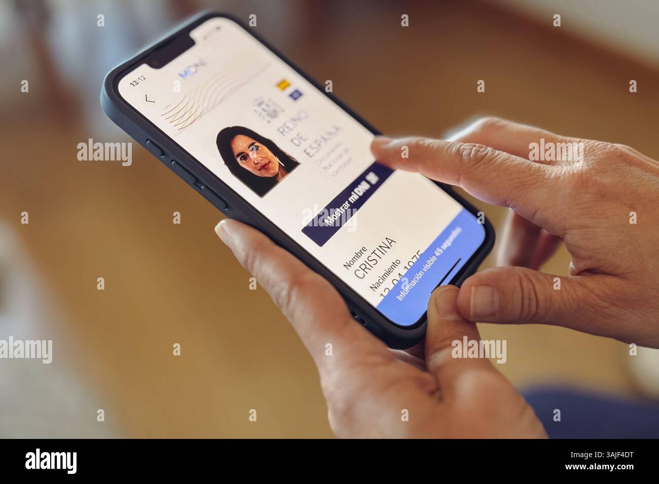 Hands of woman using the app for the new Spanish digital ID card that ...