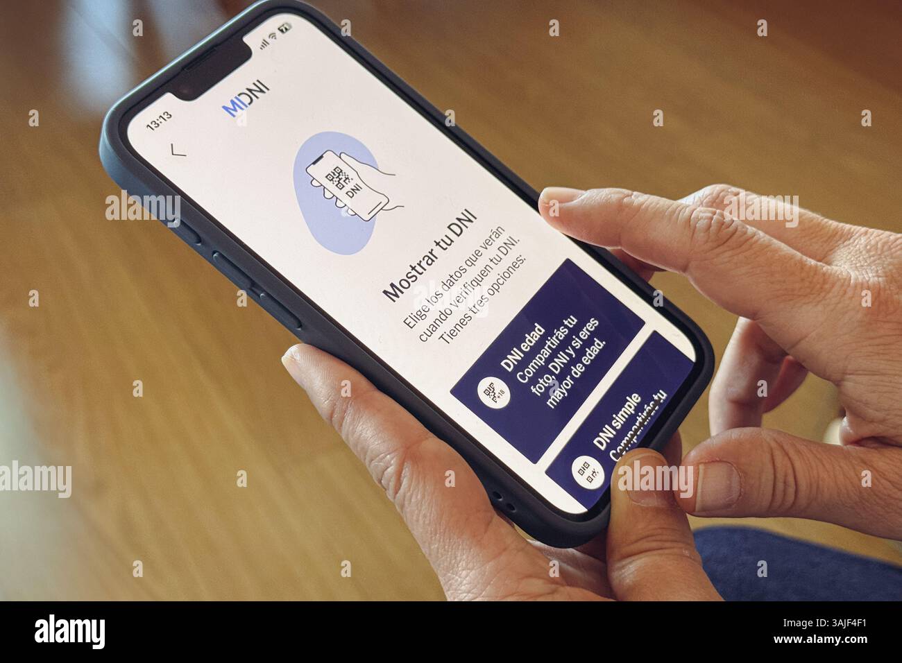 Hands of woman using the app for the new Spanish digital ID card that ...
