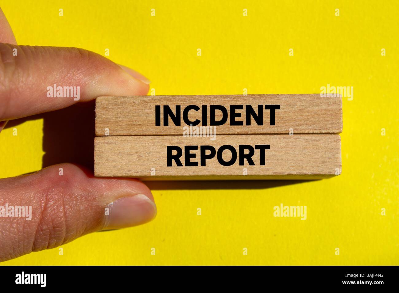Incident report message written on wooden blocks on yellow background ...