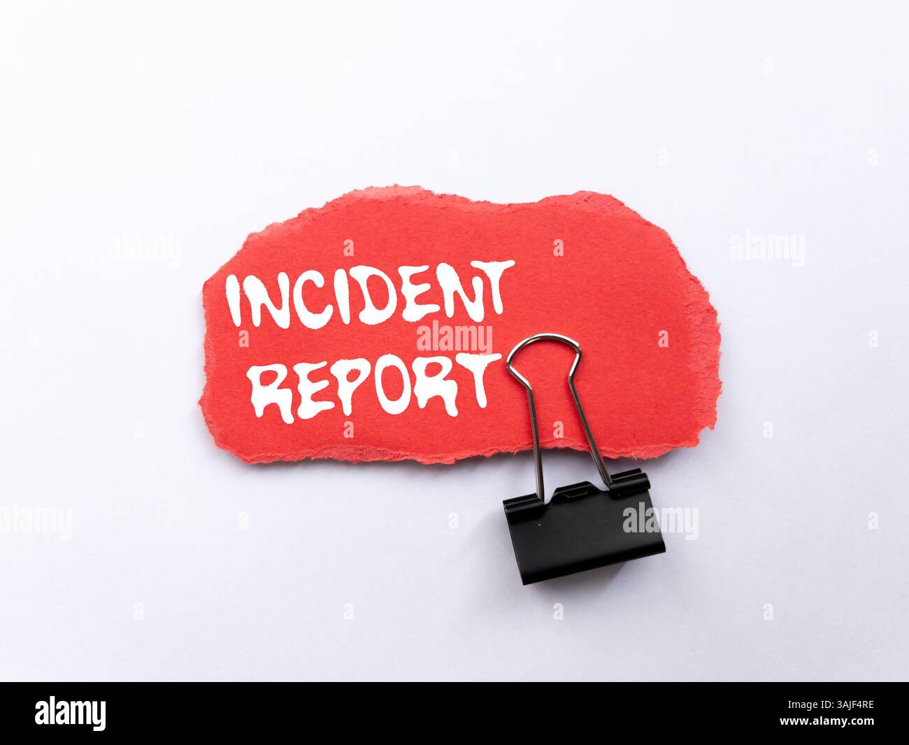 Incident report message written on ripped torn red paper piece on white background. Conceptual ...