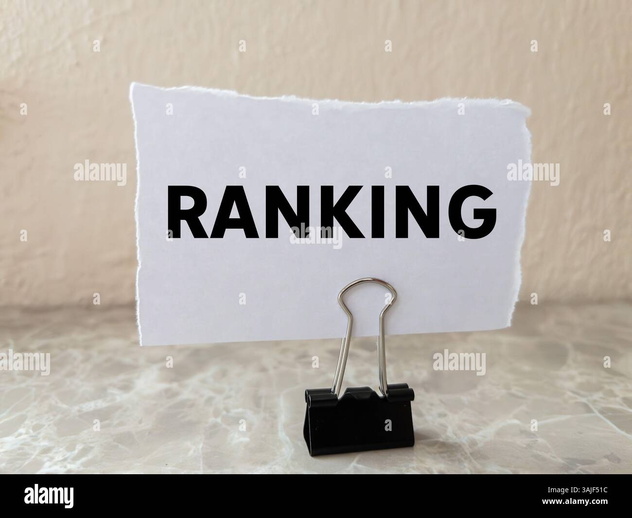 Ranking message written on ripped torn white paper piece on wall ...