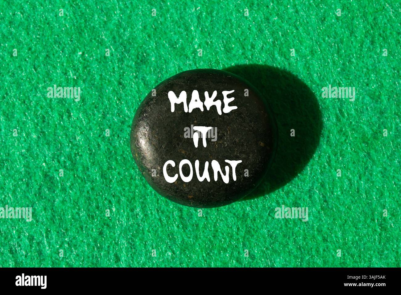 Make it count message written on black stone on green background ...