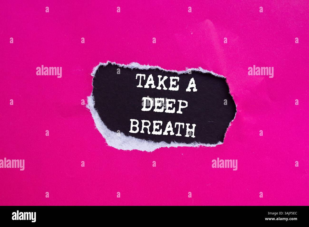 Take a deep breath message written on ripped torn pink paper on black ...