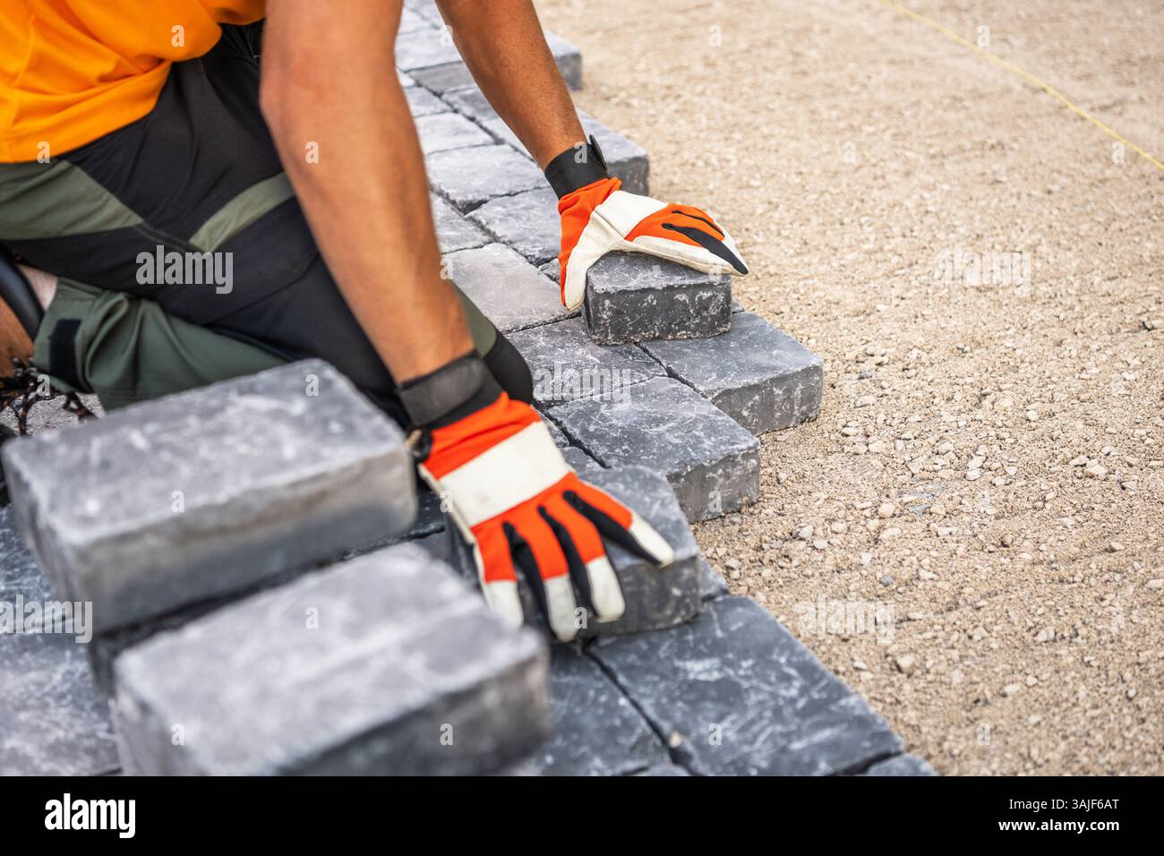 Worker wearing gloves laying hi-res stock photography and images - Alamy
