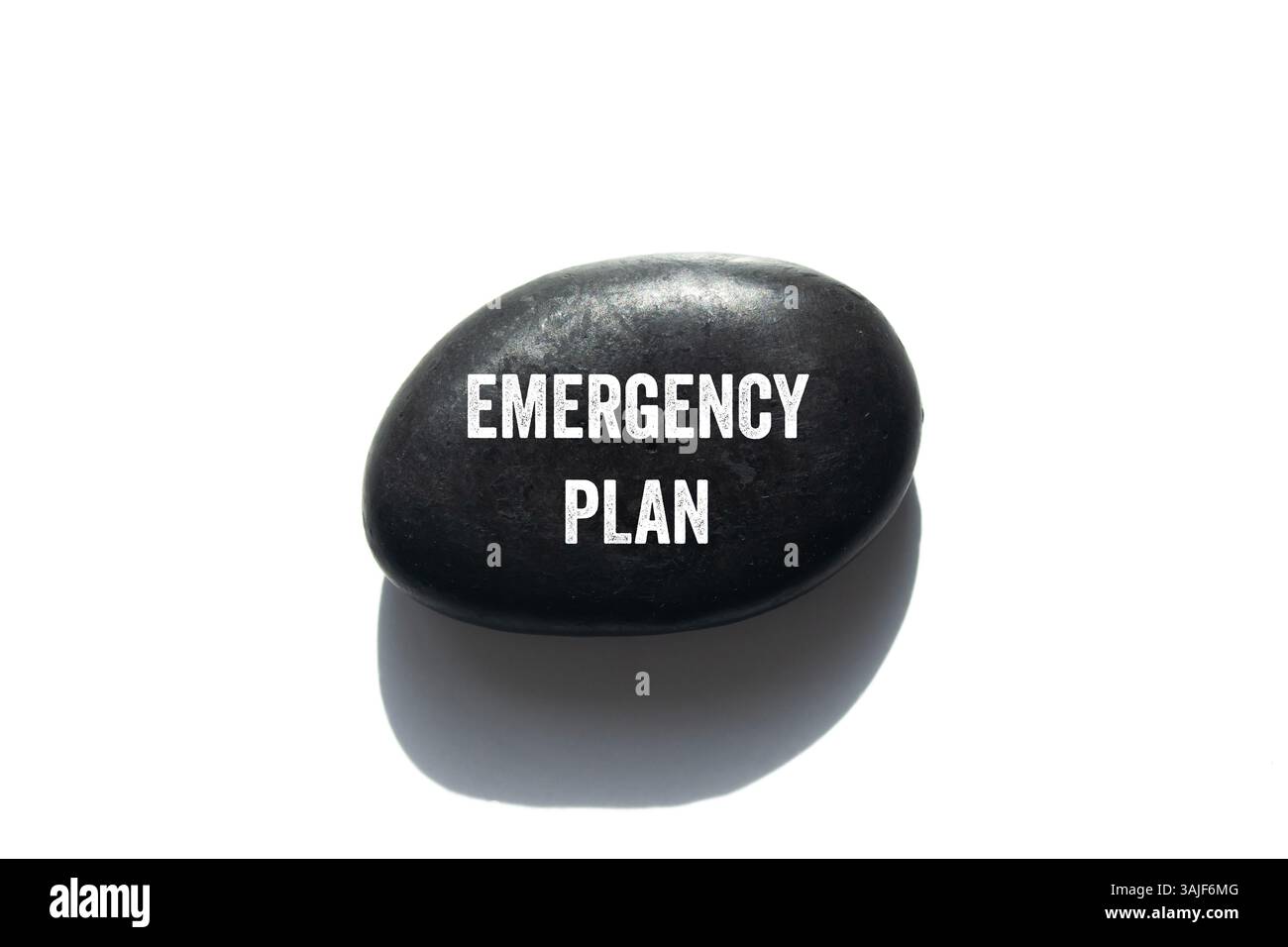 Emergency plan message written on black stone on white background ...
