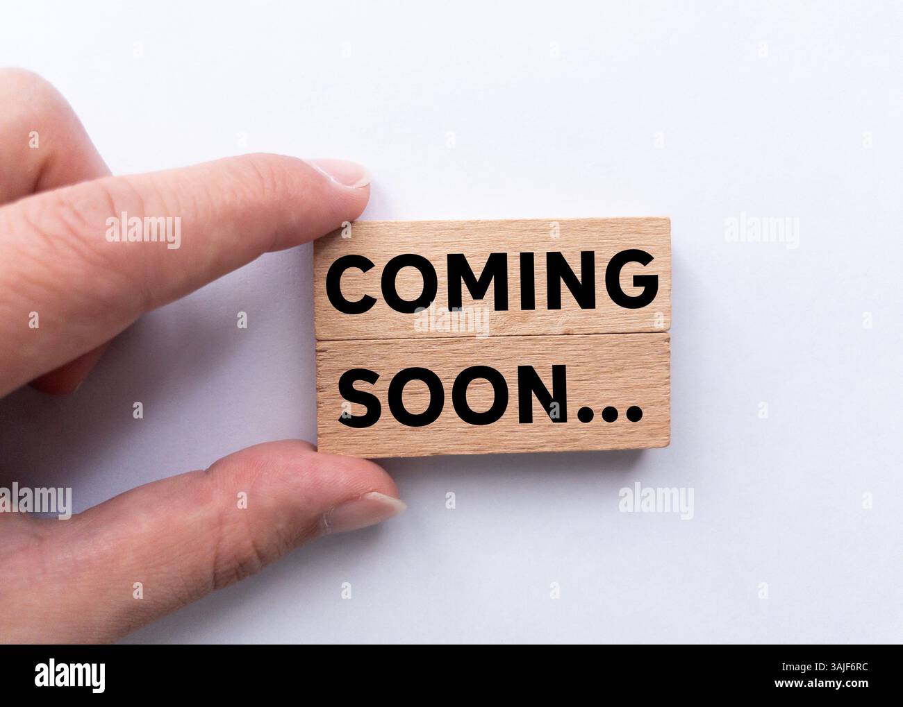 Coming soon message written on wooden blocks on white background ...