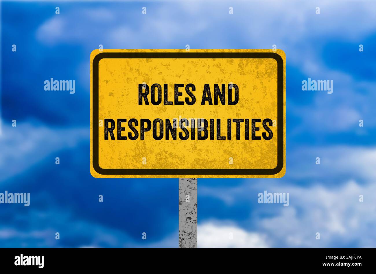 Roles and responsibilities message written on yellow metal sign. Conceptual roles and ...