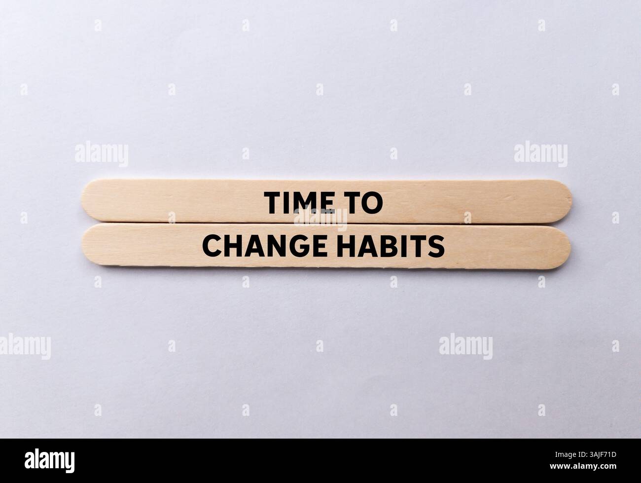 Time to change habits message written on wooden sticks on white ...