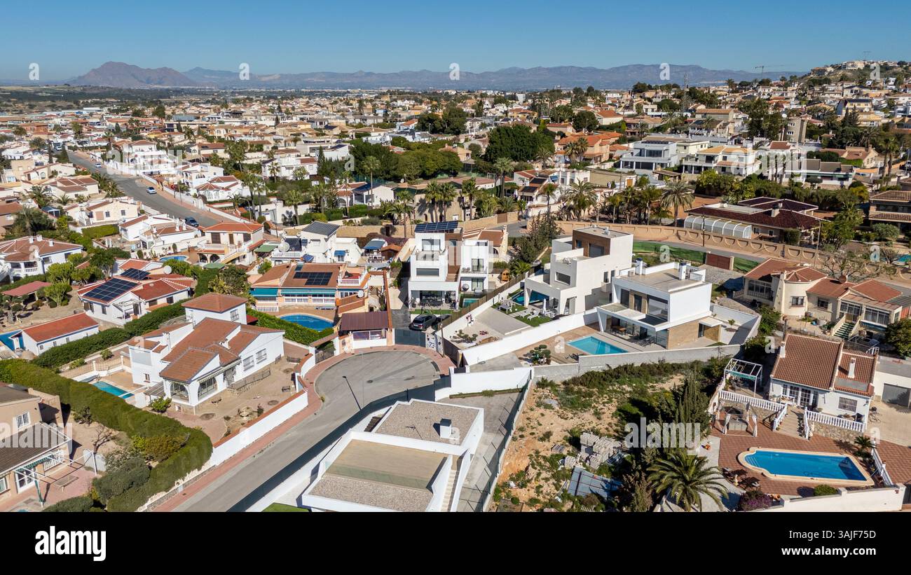 Expansive aerial view showing a suburban residential area with mountain ...