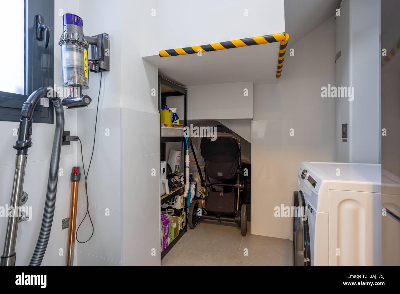 Compact laundry and utility room equipped with a washing machine ...