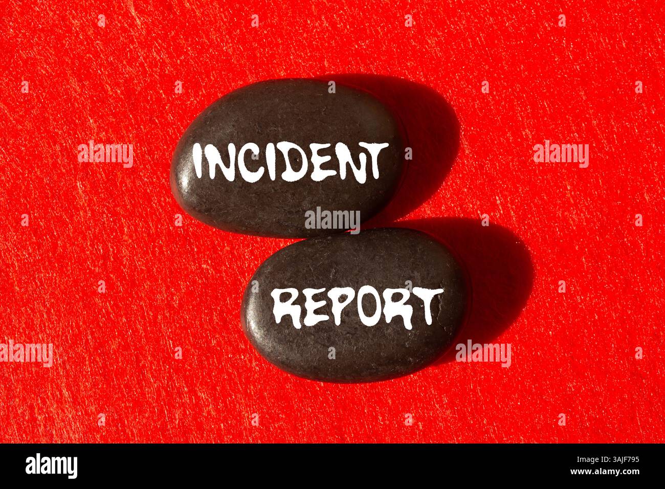 Incident report message written on black stones on red background ...