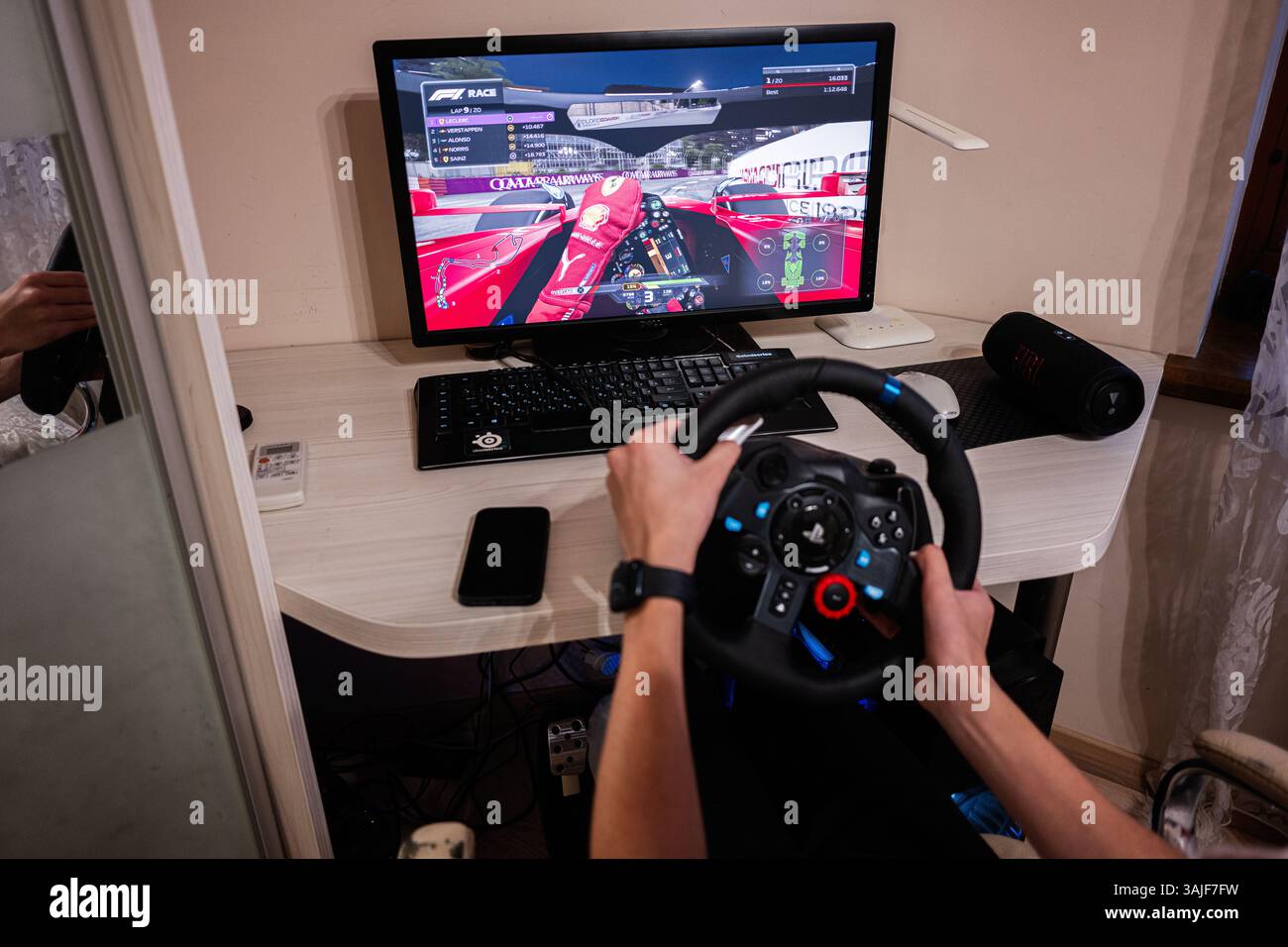 Kyiv, Ukraine - April 08, 2025: A gamer actively engaged in virtual F1 ...