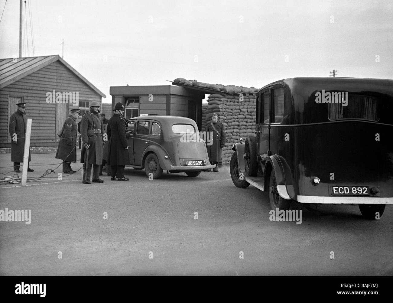 Lord Redesdale chats to a guard as his car leads the ambulance through ...