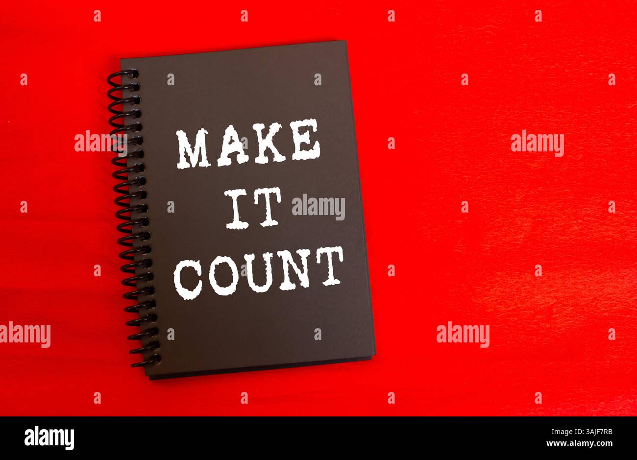 Make it count message written on black notebook page on red background ...