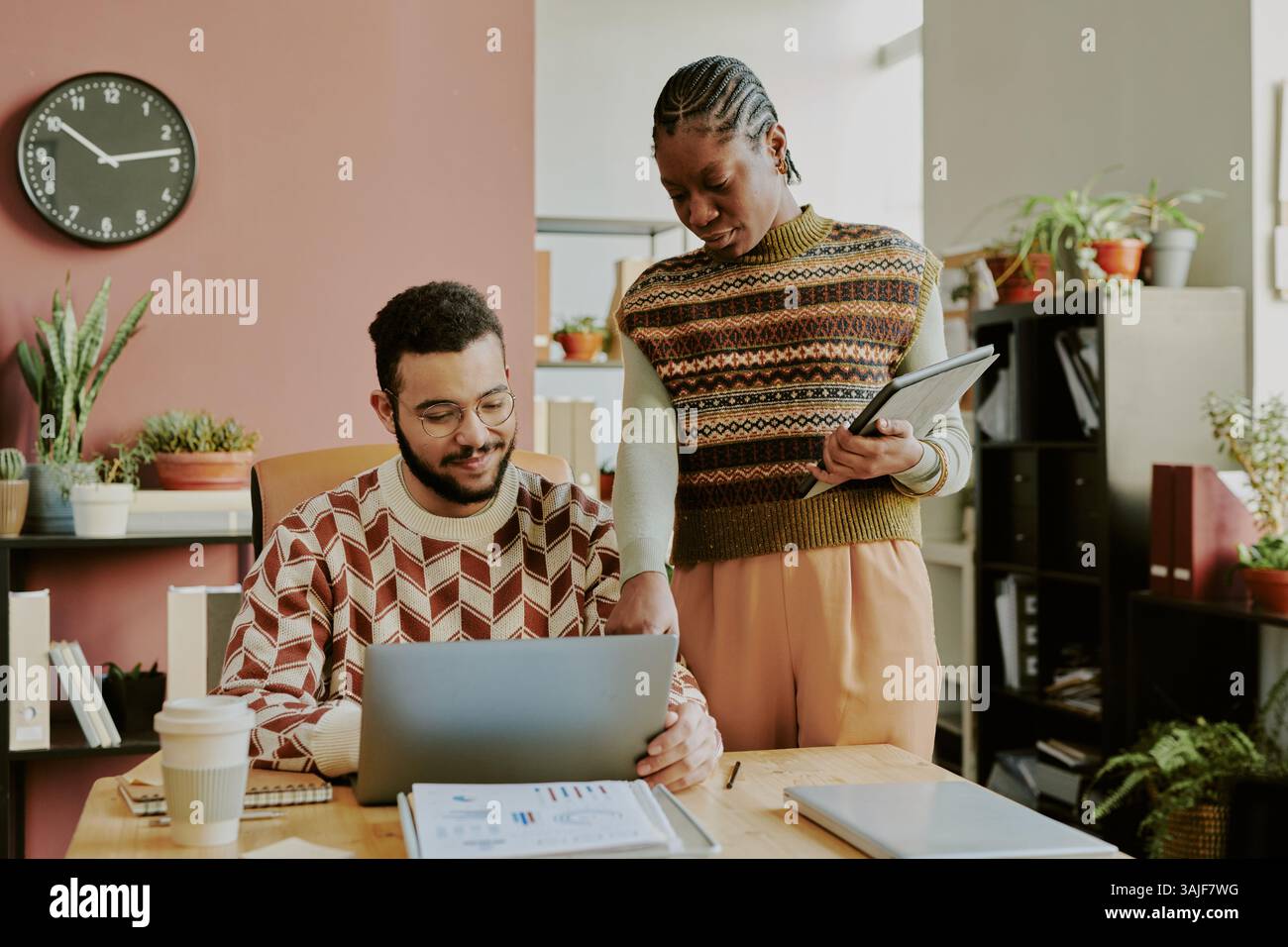 Medium shot of professional female programmer with tablet in hand ...