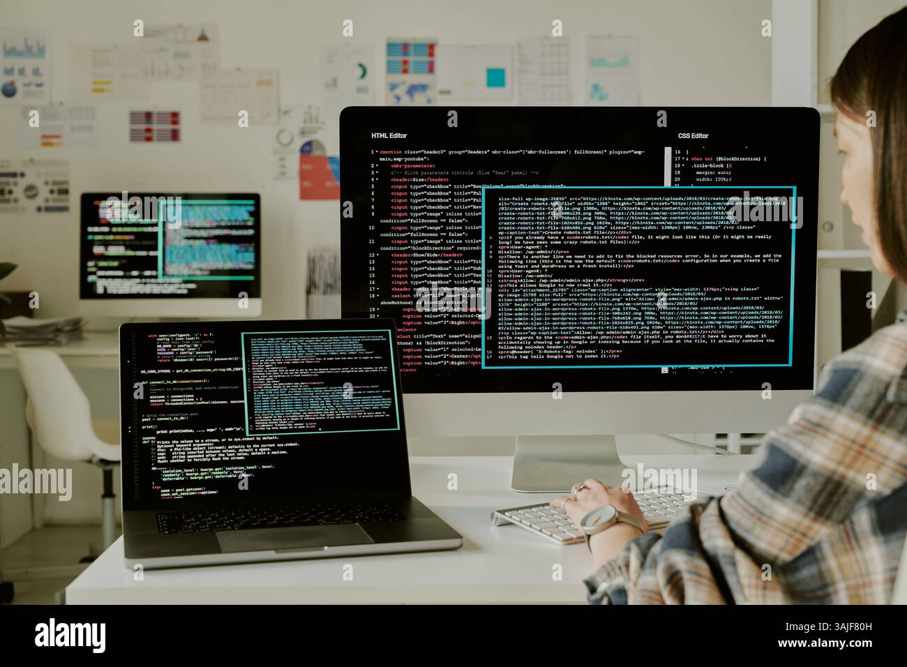 Medium shot of unrecognizable female programmer coding on computer in office, her workplace ...