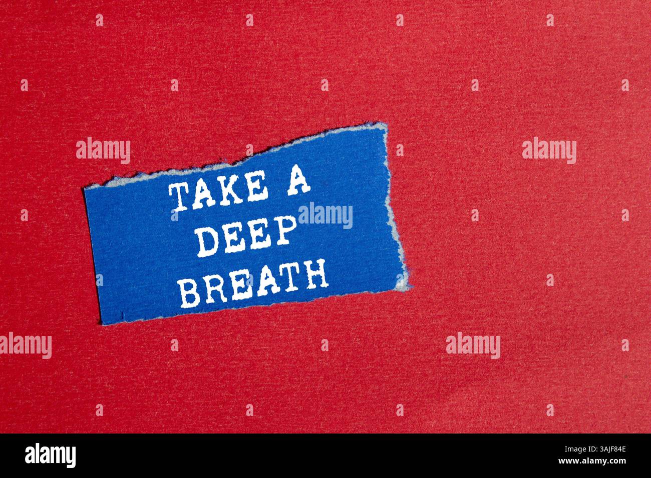 Take a deep breath message written on ripped torn blue paper piece on ...