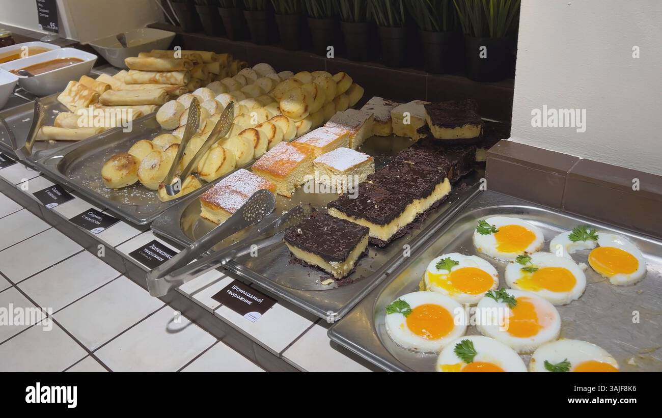 Hotel breakfast buffet offering fried eggs, pancakes, pastries and ...