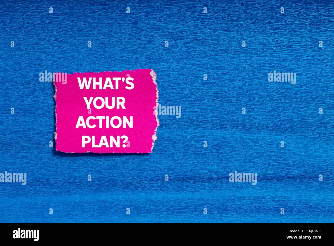 What's your action plan message written on ripped torn pink paper on blue background. Conceptual ...