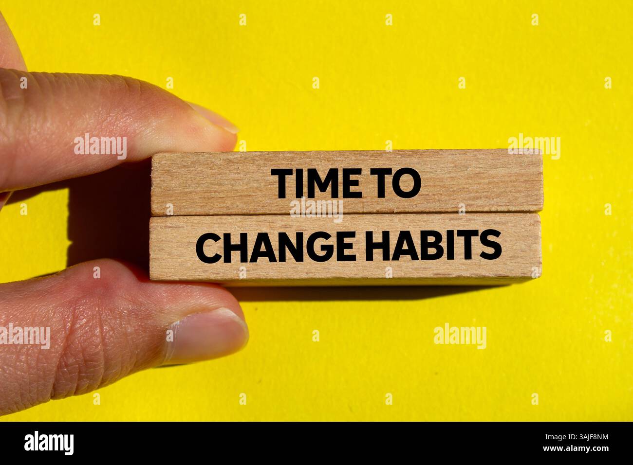 Time to change habits message written on wooden blocks on yellow ...