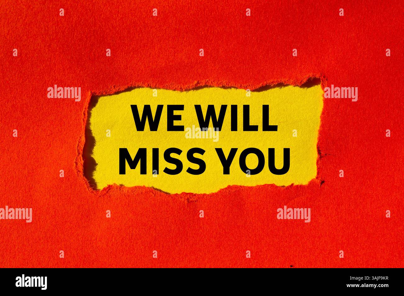 We will miss you message written on ripped torn red paper on yellow background. Conceptual we ...