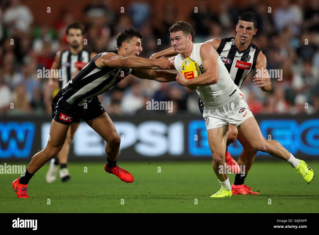 Adelaide, Australia. 11th Apr, 2025. Tom Hanily of the Swans is tackled ...
