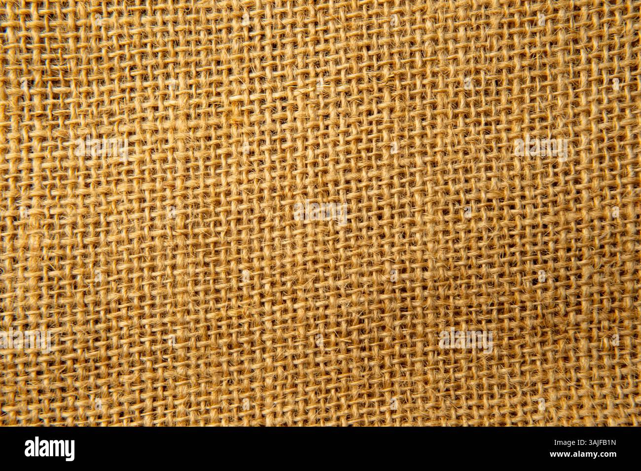 A tightly framed, top-down shot showcases the rough texture of burlap ...